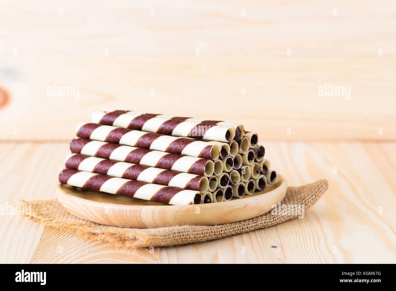Mini chocolate stick wafer stick on wooden plate Stock Photo - Alamy