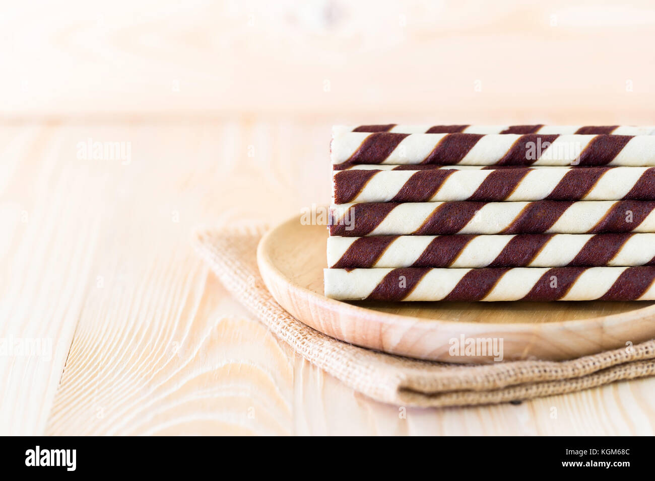 Mini chocolate stick wafer stick on wooden plate Stock Photo - Alamy