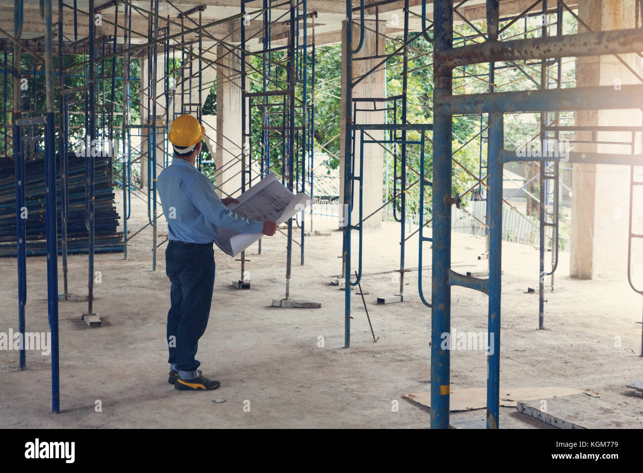 Construction concepts, Engineer and Architect working at Construction Site with blueprint ...