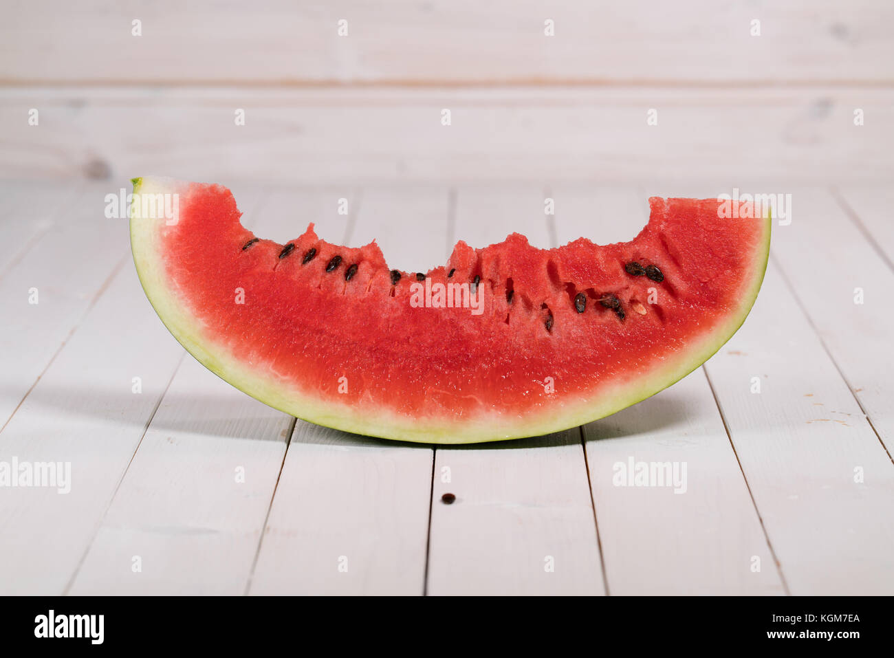 bitten slice of watermelon on a white background Stock Photo - Alamy