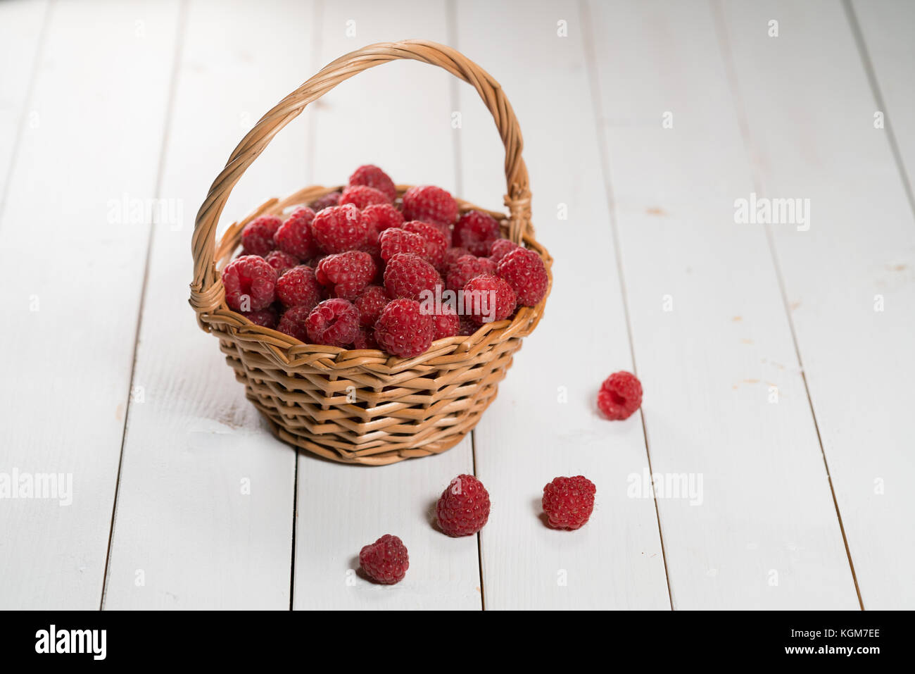 raspberries in the basket on white background Stock Photo - Alamy