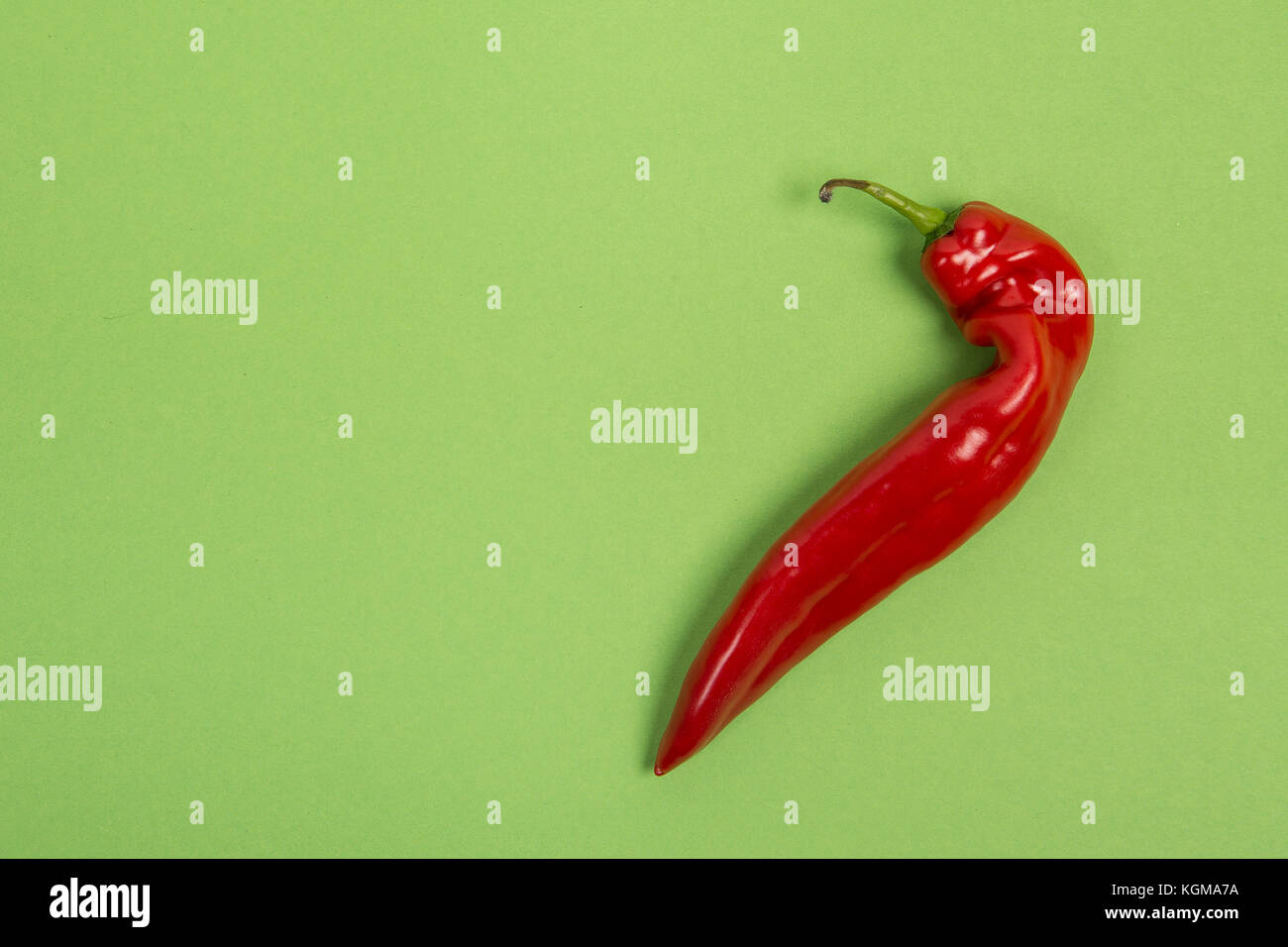 Red pointed pepper on a green background with space for copy Stock ...