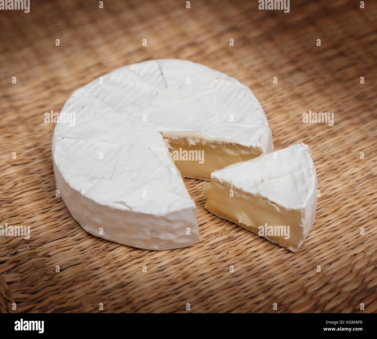 Fresh slice of Camembert cheese natural, on a straw Mat Stock Photo - Alamy