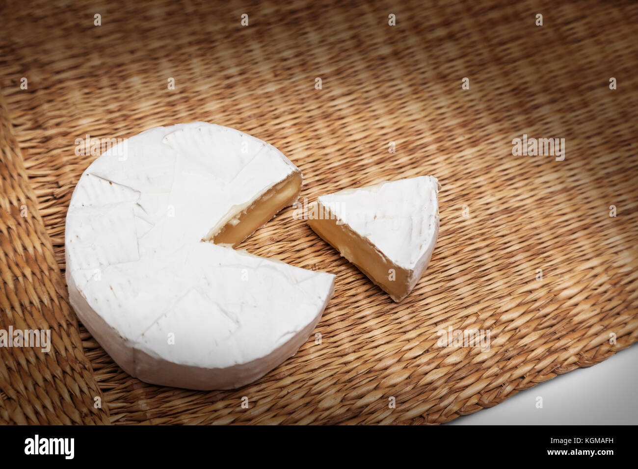 Fresh slice of Camembert cheese natural, on a straw Mat Stock Photo - Alamy