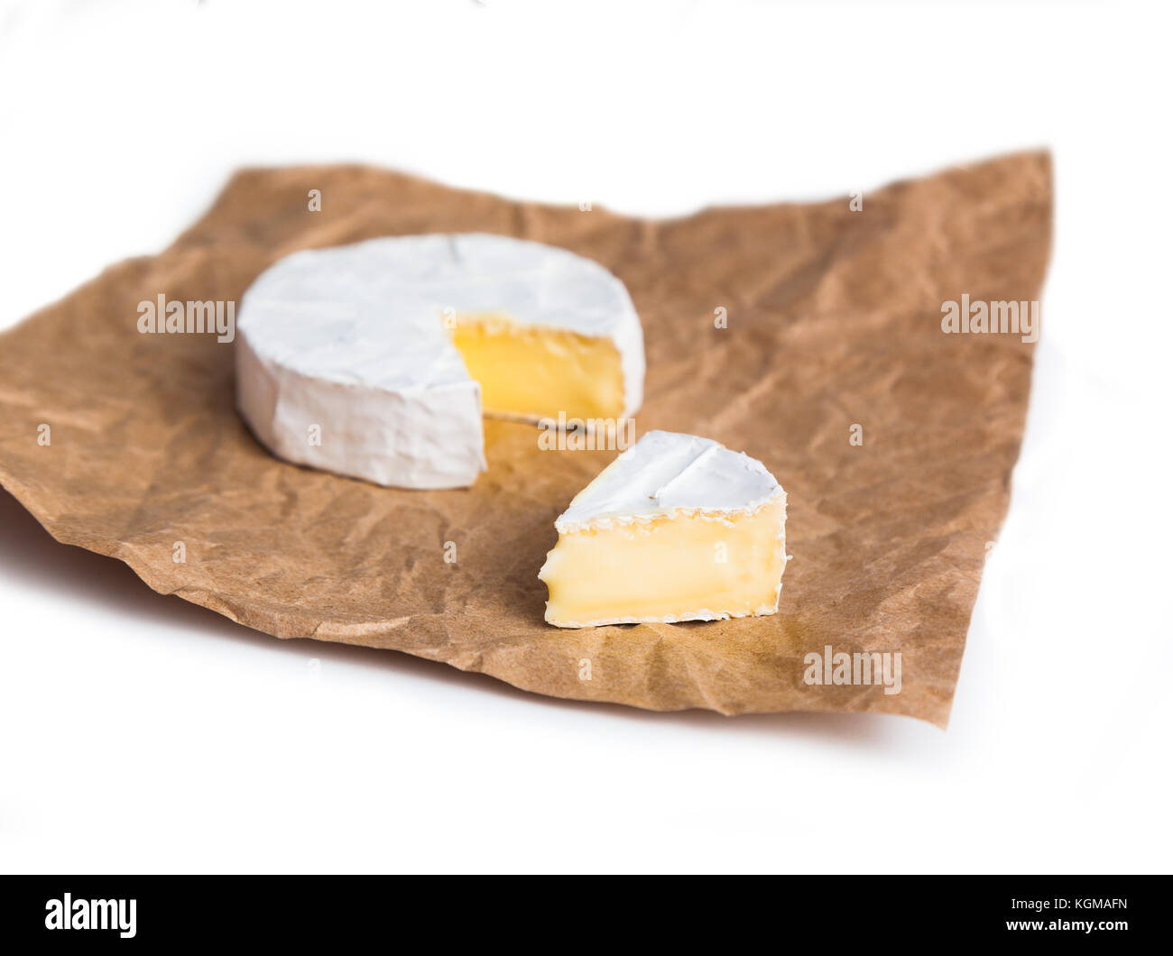 Fresh slice Camembert cheese natural, on Kraft paper brown background ...