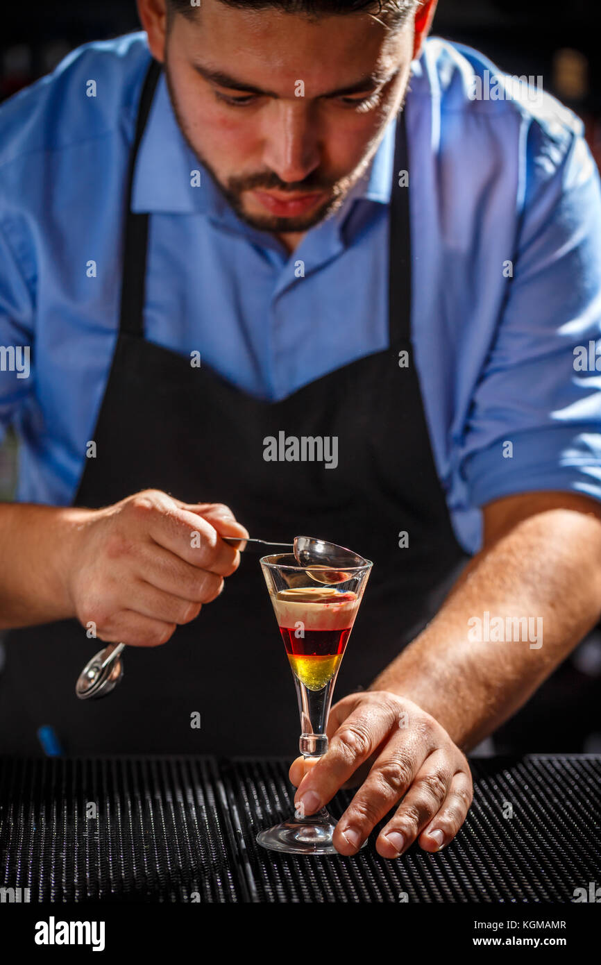 Bartender preparing layered cocktail on bar counter Stock Photo - Alamy