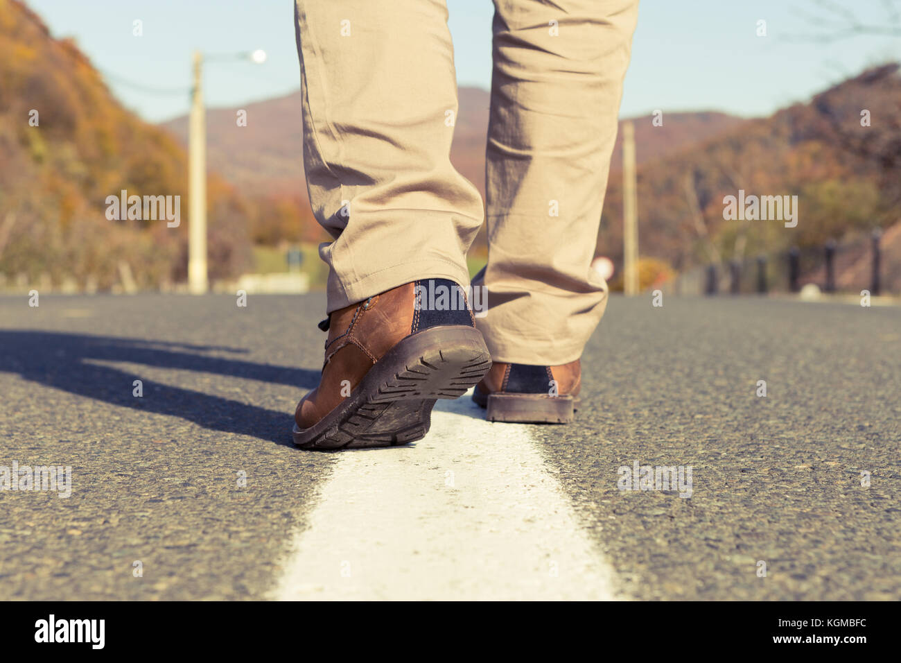 Back view of male feet walking and wearing autumn real or genuine ...