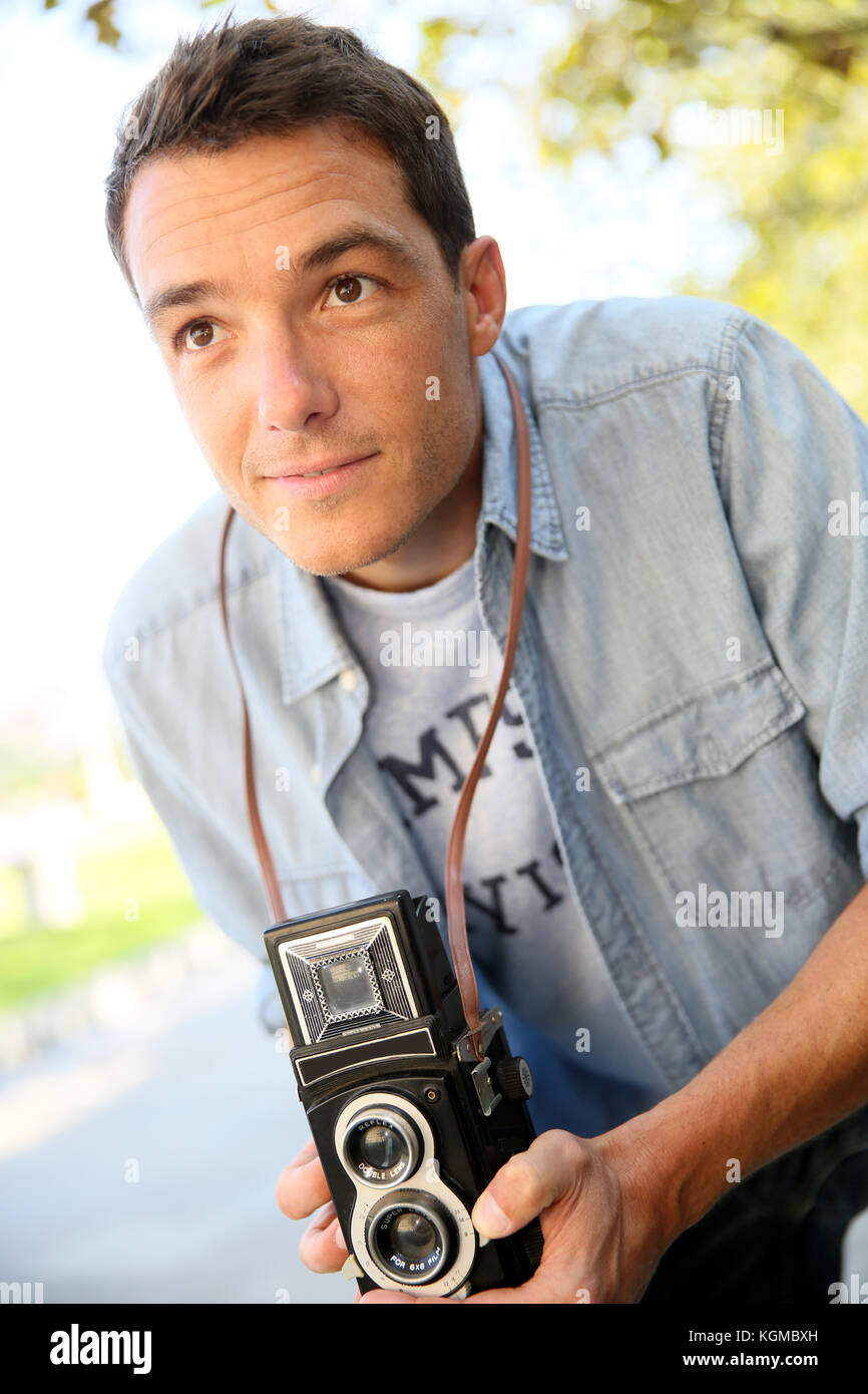 Photographer using vintage camera Stock Photo - Alamy