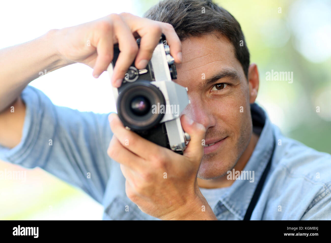 Photographer shooting outside with old camera Stock Photo - Alamy