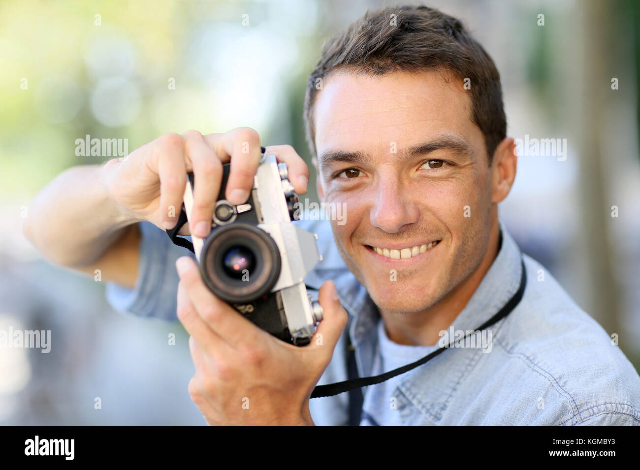 Photographer shooting outside with old camera Stock Photo - Alamy