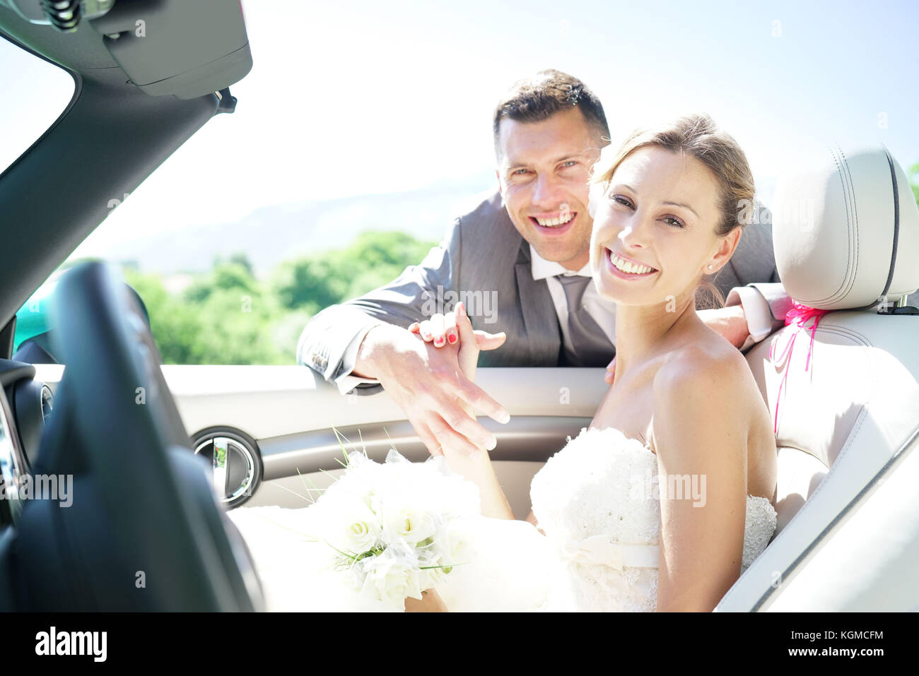 Portrait of beautiful smiling bride sitting in convertible car Stock ...