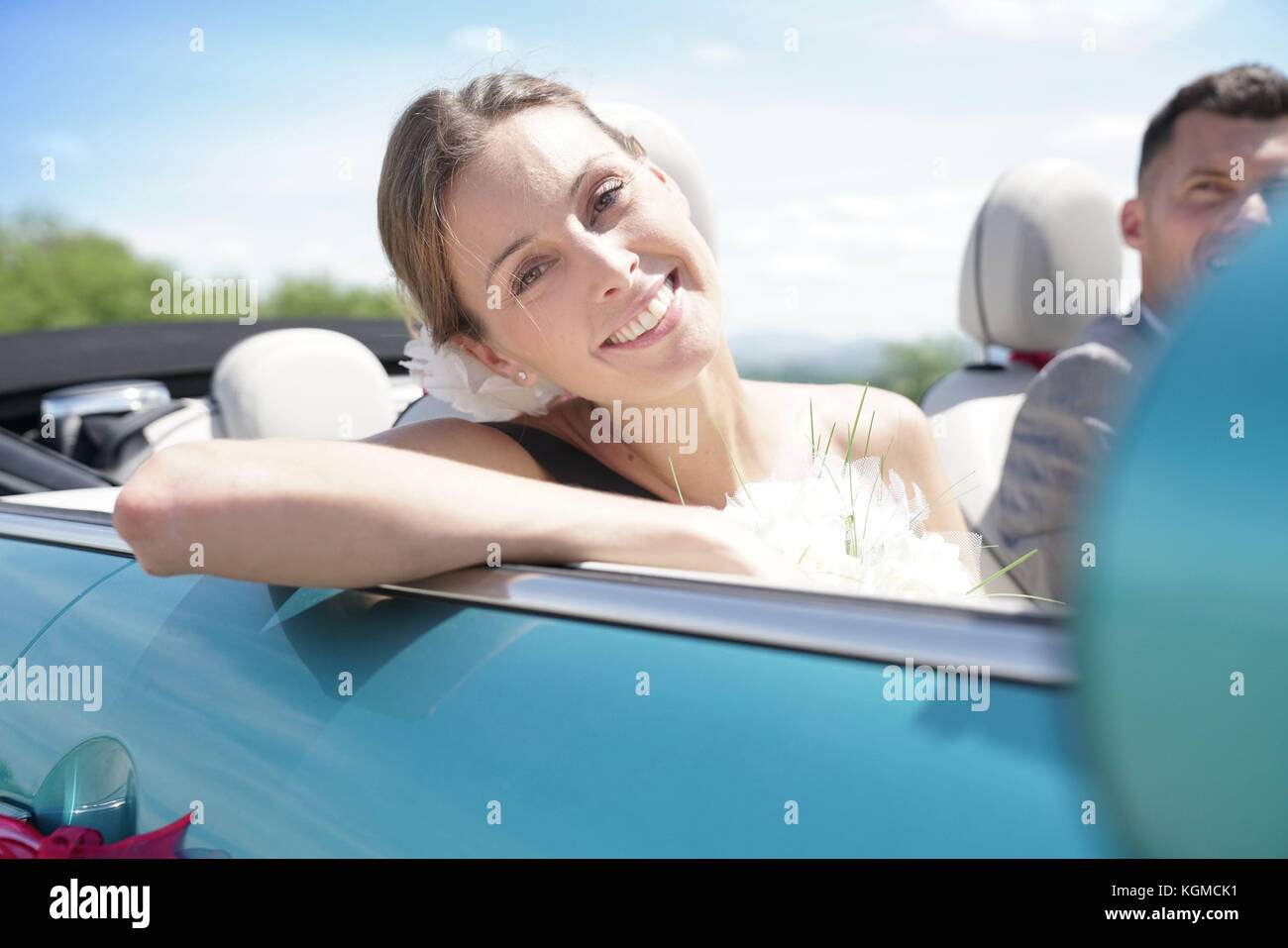 Portrait of beautiful smiling bride riding in convertible car Stock ...