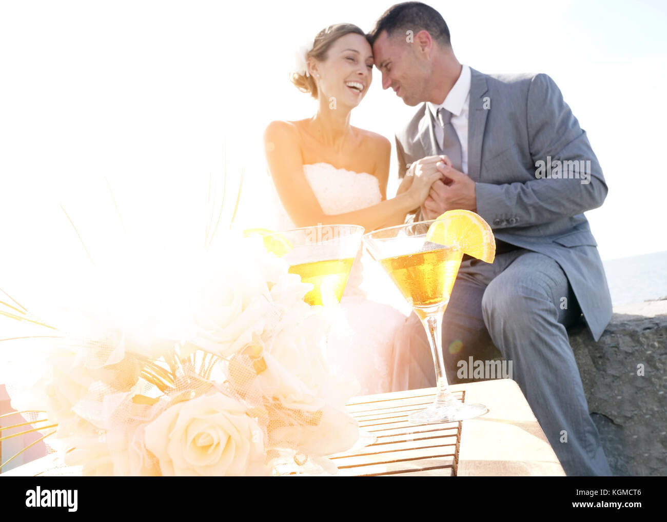 Wedding cocktail, bride and groom in background Stock Photo - Alamy