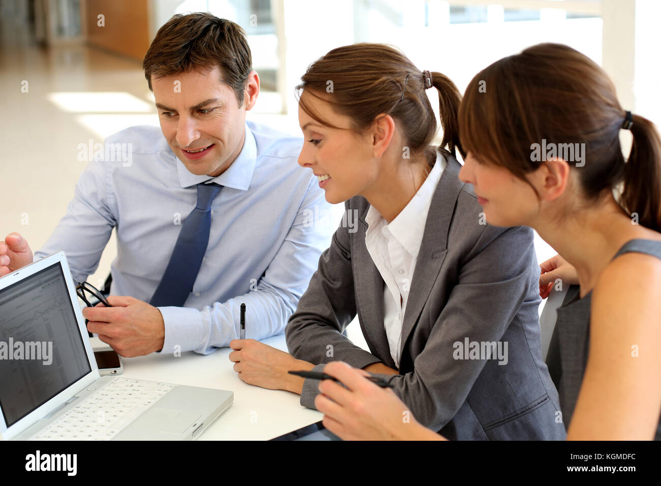 Business presentation around table Stock Photo - Alamy
