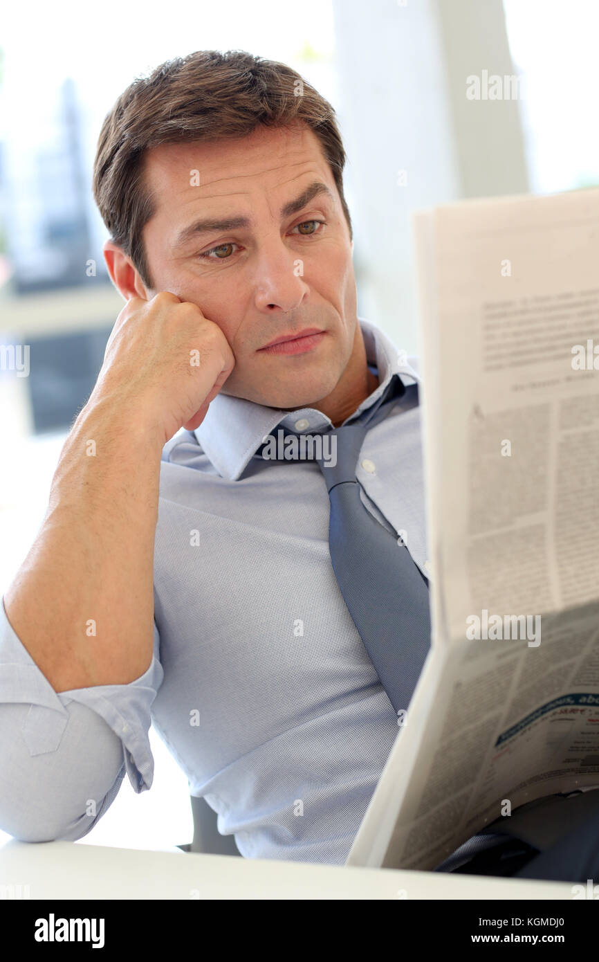 Businessman reading newspaper in office Stock Photo - Alamy Businessman reading newspaper in office Stock Photo - Alamy