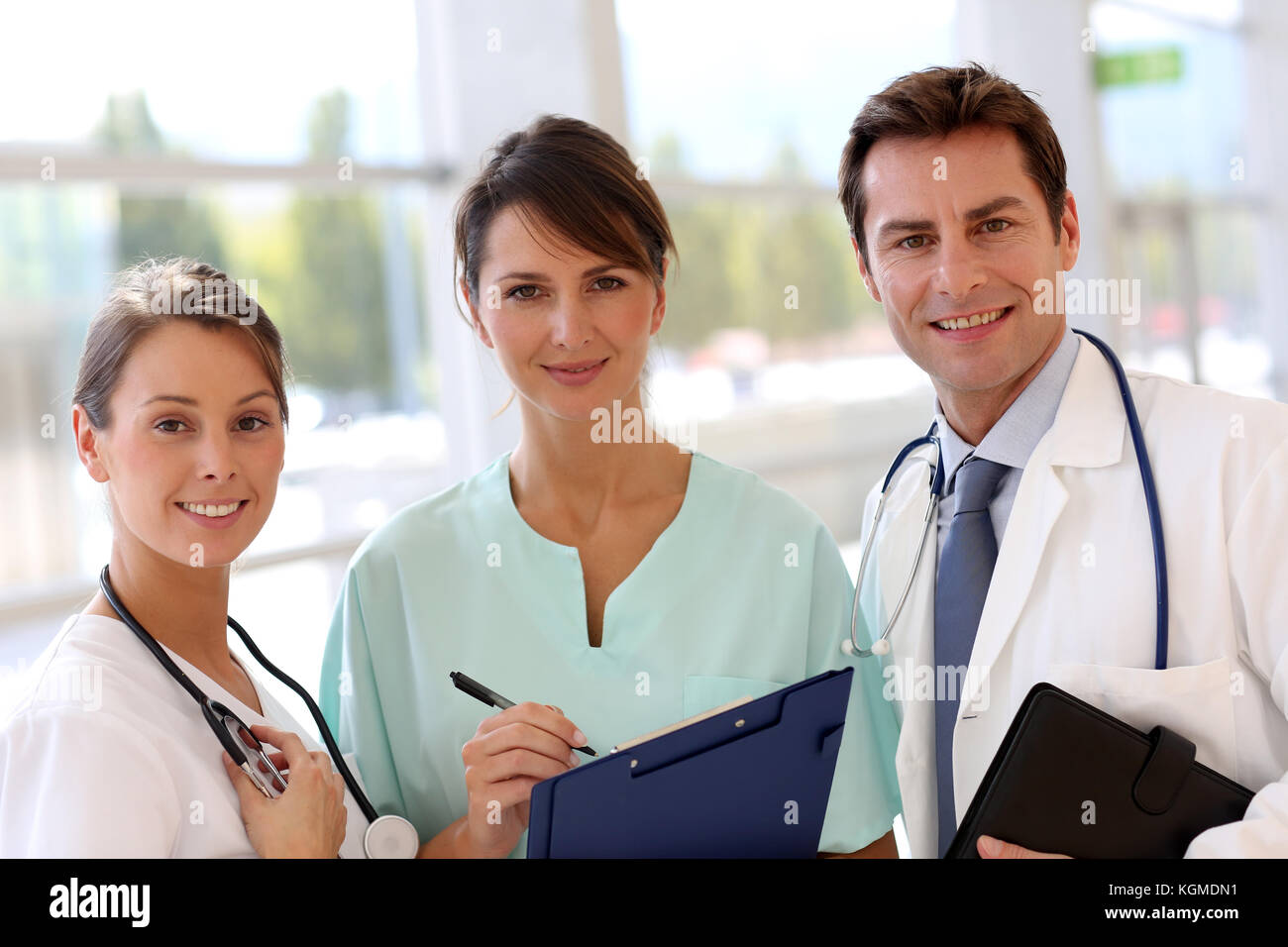 Smiling medical team standing in hall Stock Photo - Alamy