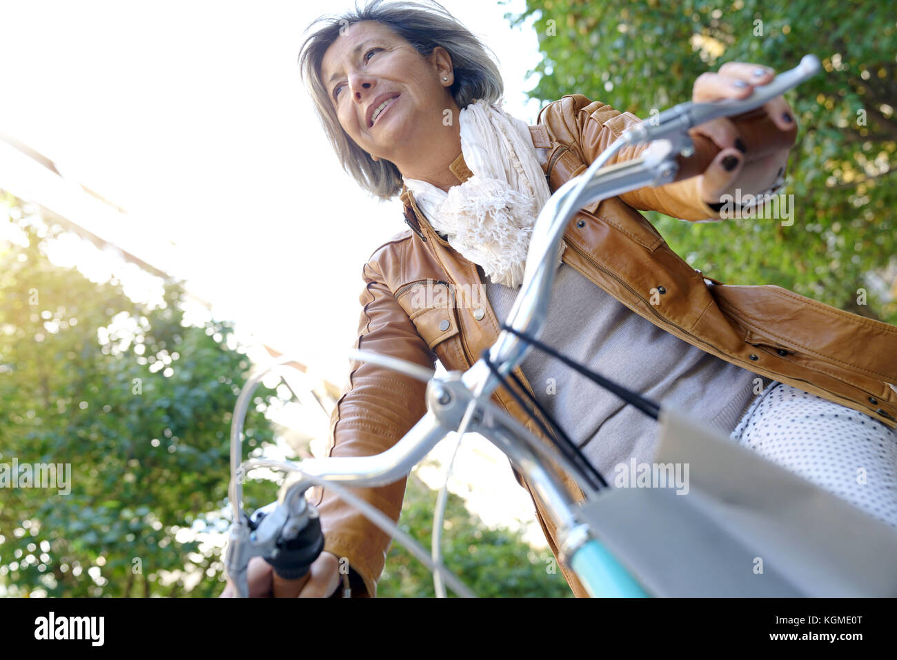 Mature woman riding bike hi-res stock photography and images - Alamy