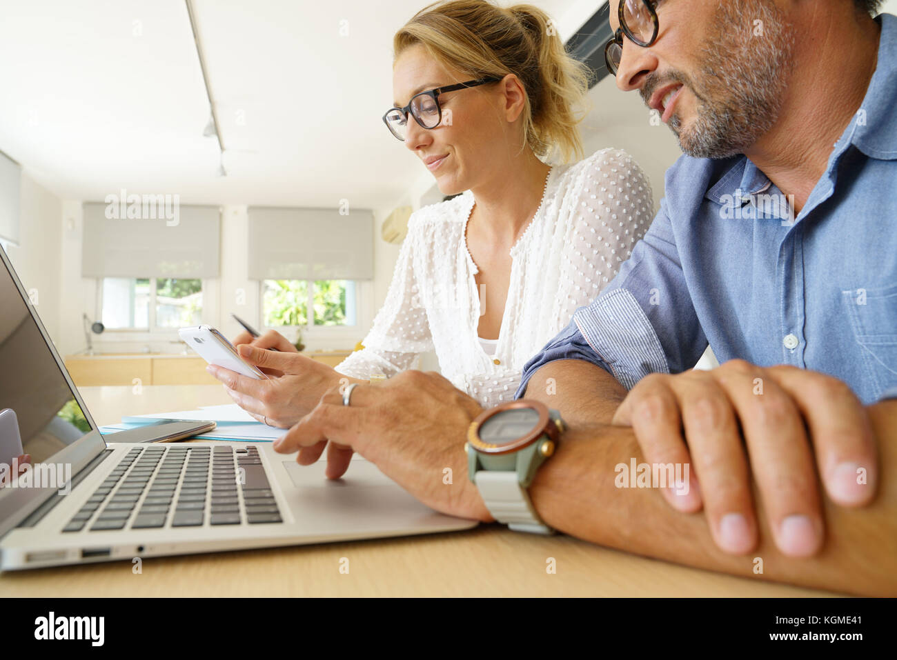 Business team working on project using laptop Stock Photo - Alamy