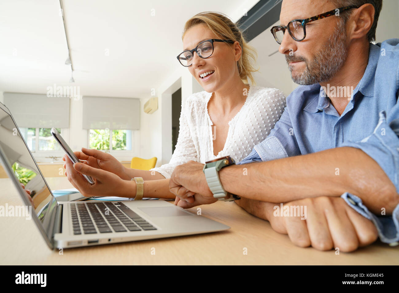 Business team working on project using laptop Stock Photo - Alamy