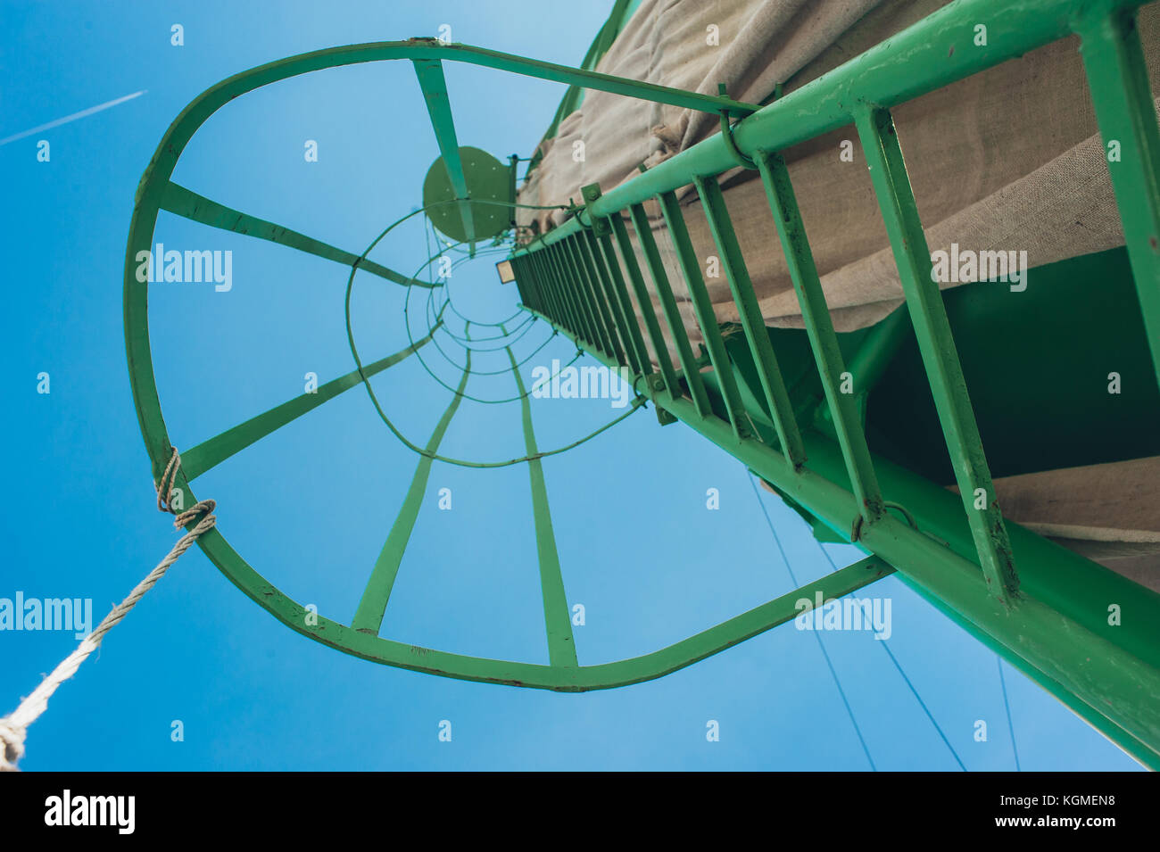 High green metal ladder on the construction site. Original angle first ...