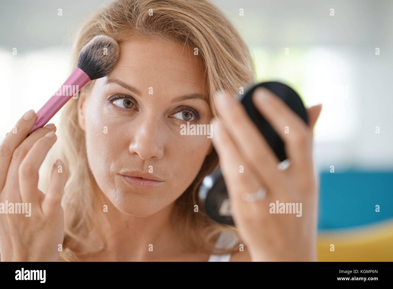Woman putting on foundation hi-res stock photography and images - Alamy