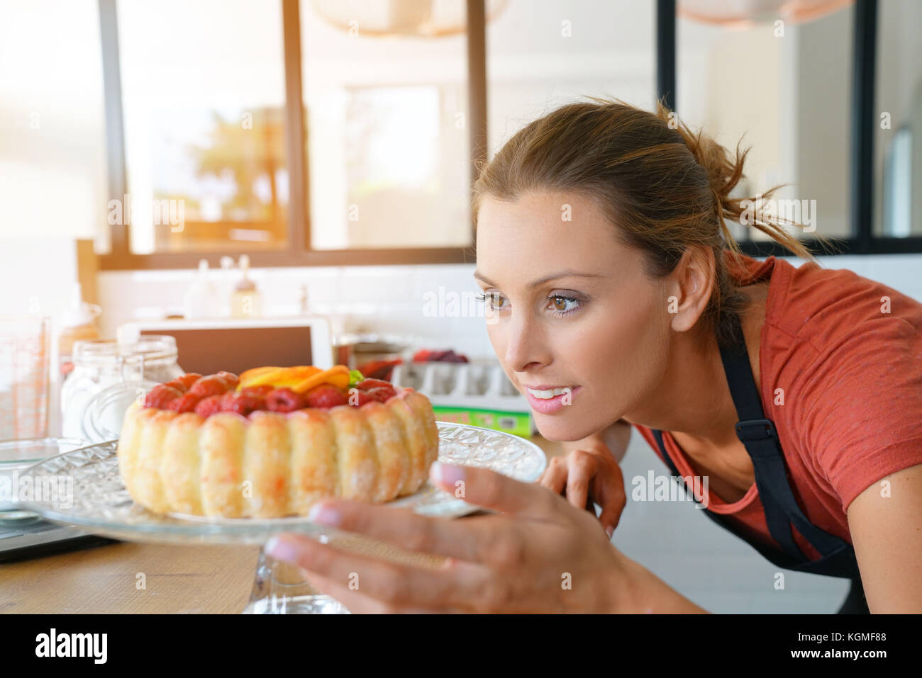 Woman pastry cook checking homemade raspberry cake Stock Photo - Alamy