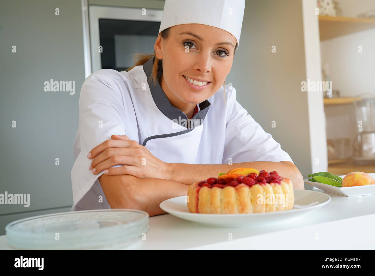 Portrait of pastry chef standing by raspberry cake Stock Photo - Alamy