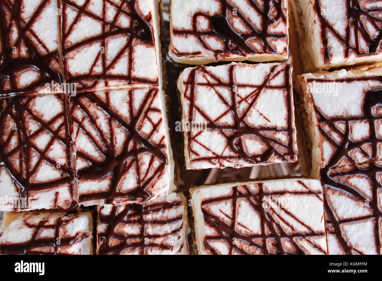 Chocolate cake with cream on top, cut in square pieces, view from above ...