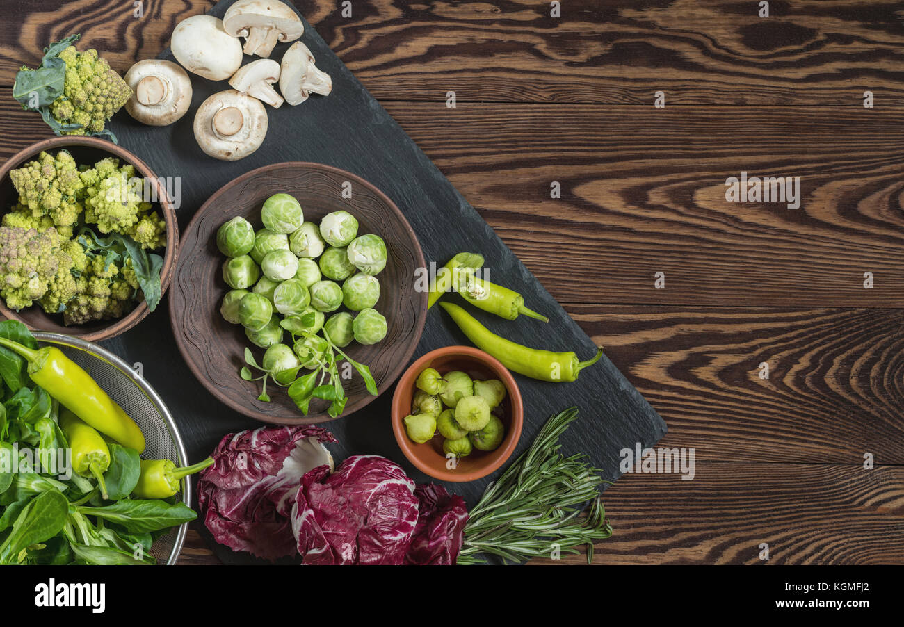 Fresh organic vegetables from the garden on wooden background. Top view ...