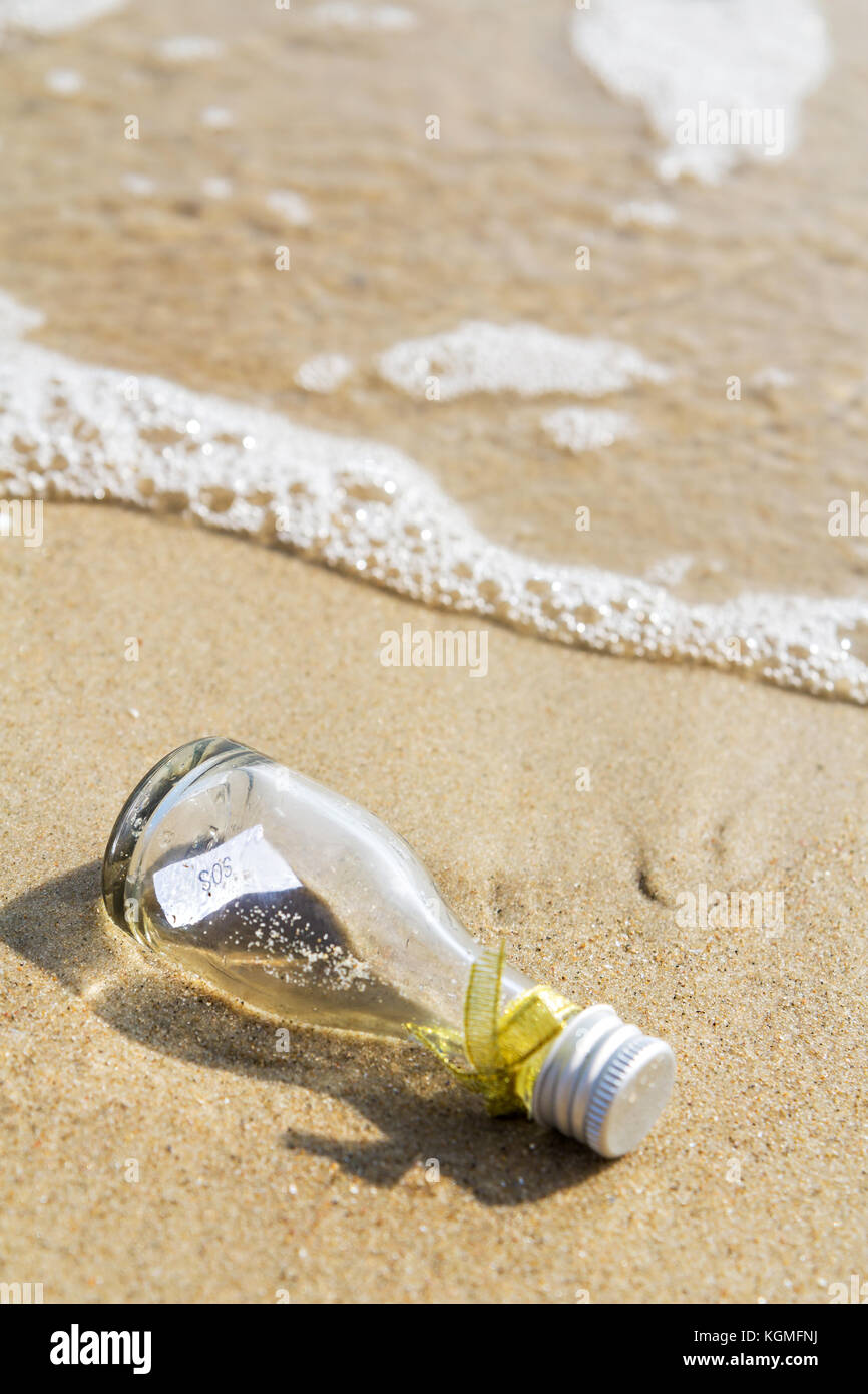 SOS message in glass bottle on the beach Stock Photo - Alamy