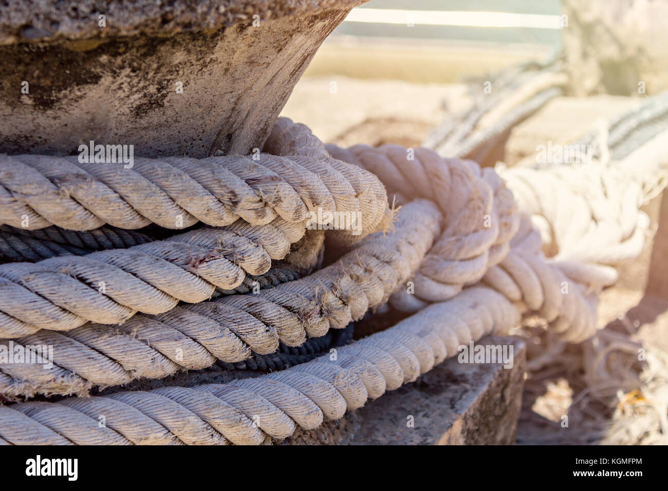 Old thick naval Rope on a Pier with sun flare Stock Photo - Alamy