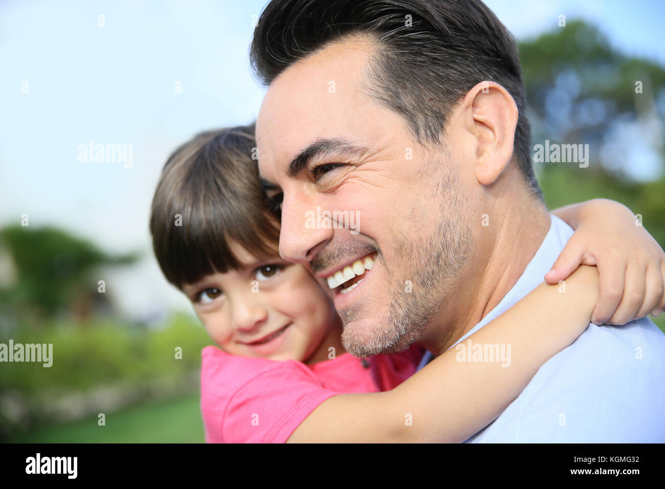 Portrait of little girl hugging her daddy Stock Photo - Alamy