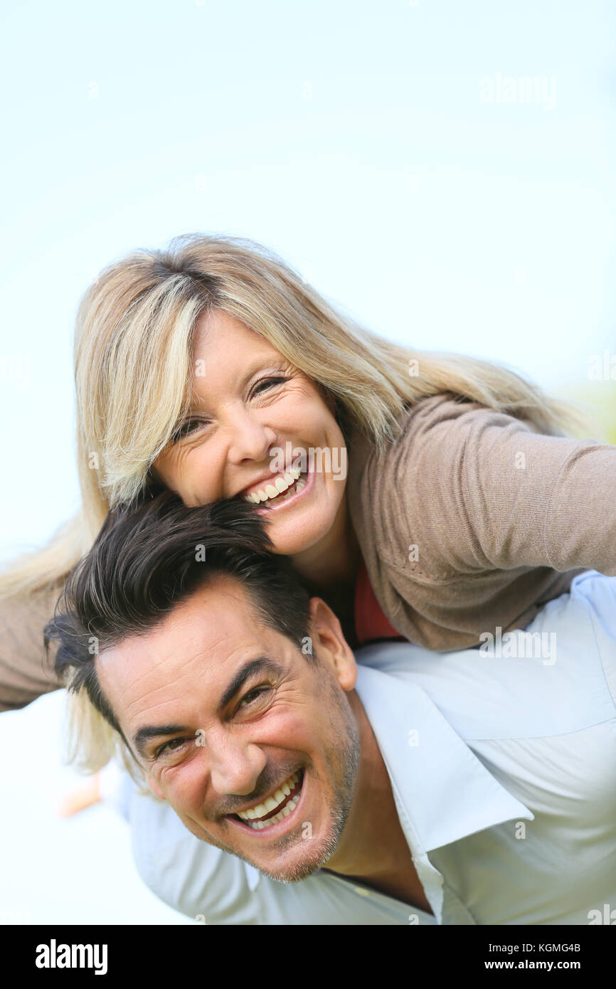 Mature man giving piggyback ride to woman hi-res stock photography and ...