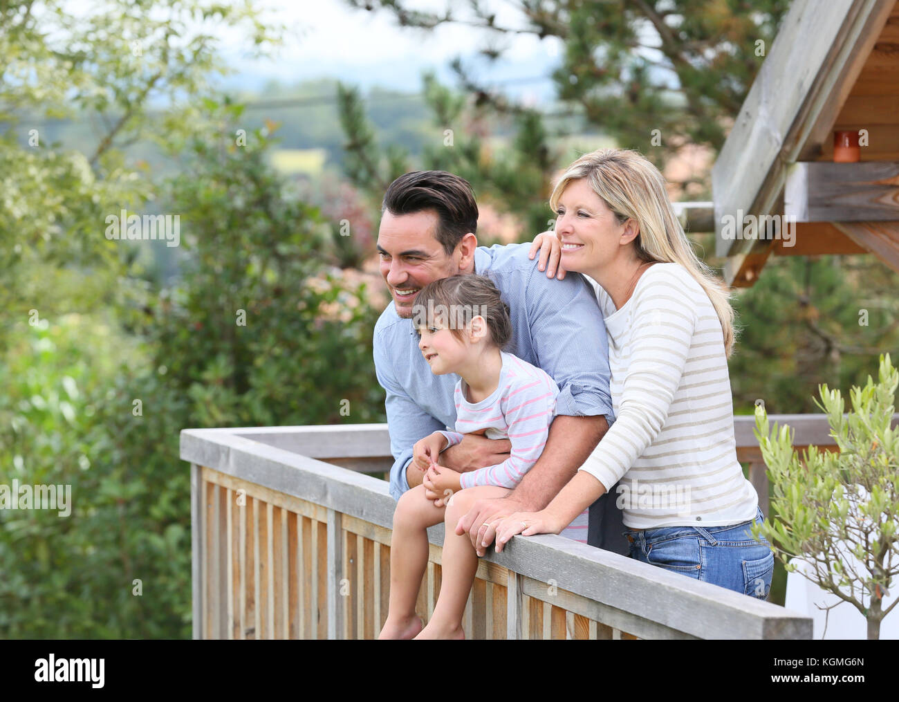 Family enjoying vacation in log cabin Stock Photo - Alamy
