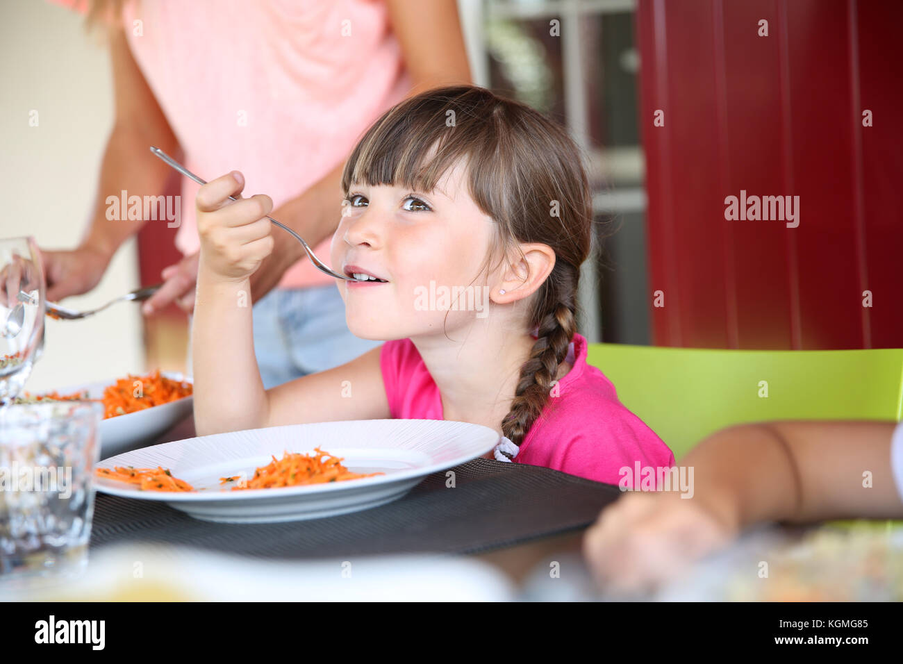 Portrait of little girl sitting at table for lunch Stock Photo - Alamy