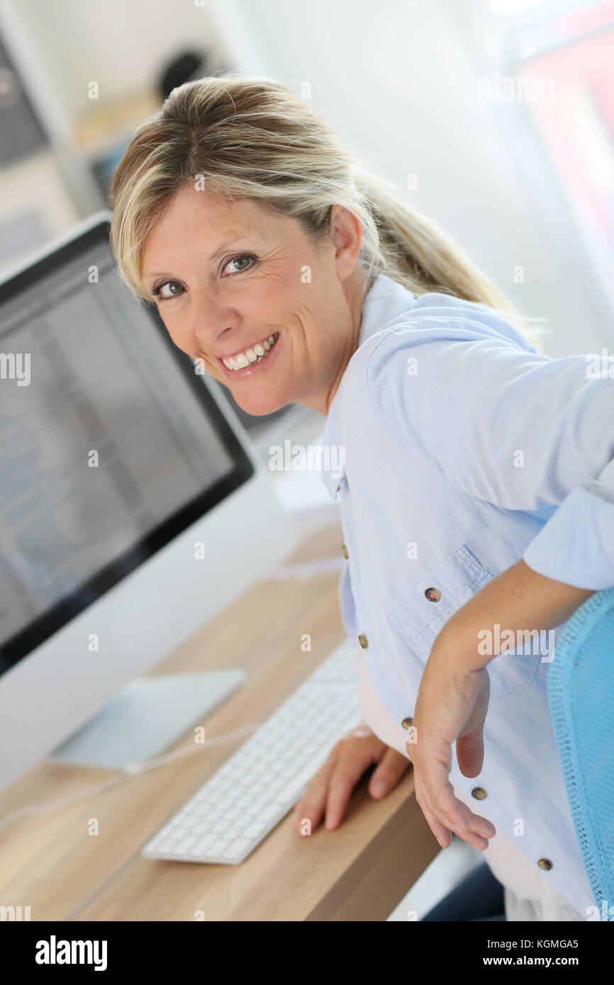 Portrait of cheerful blond woman in office Stock Photo - Alamy