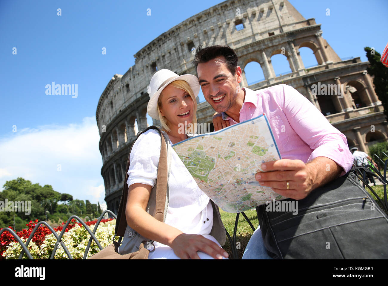 Tourists reading map in front of the Coliseum, Rome Stock Photo - Alamy