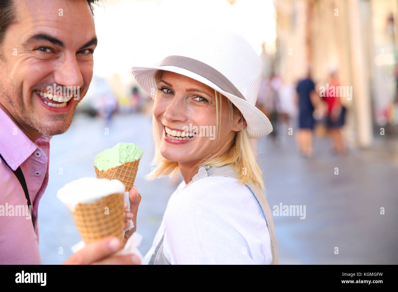 Cheerful couple in Rome eating ice cream cones Stock Photo - Alamy