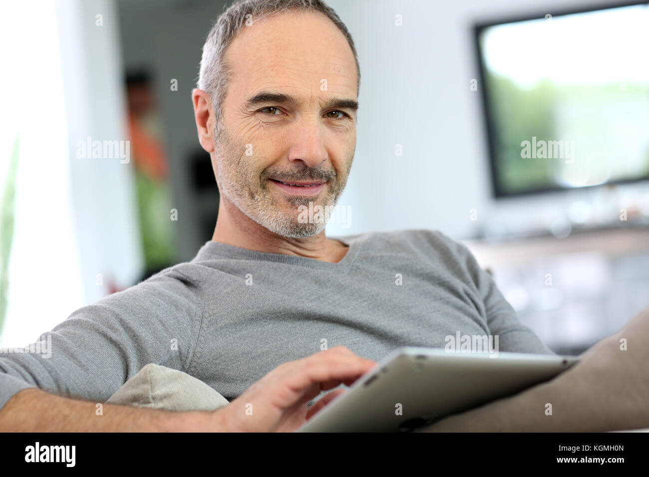 Mature man at home websurfing on internet Stock Photo - Alamy