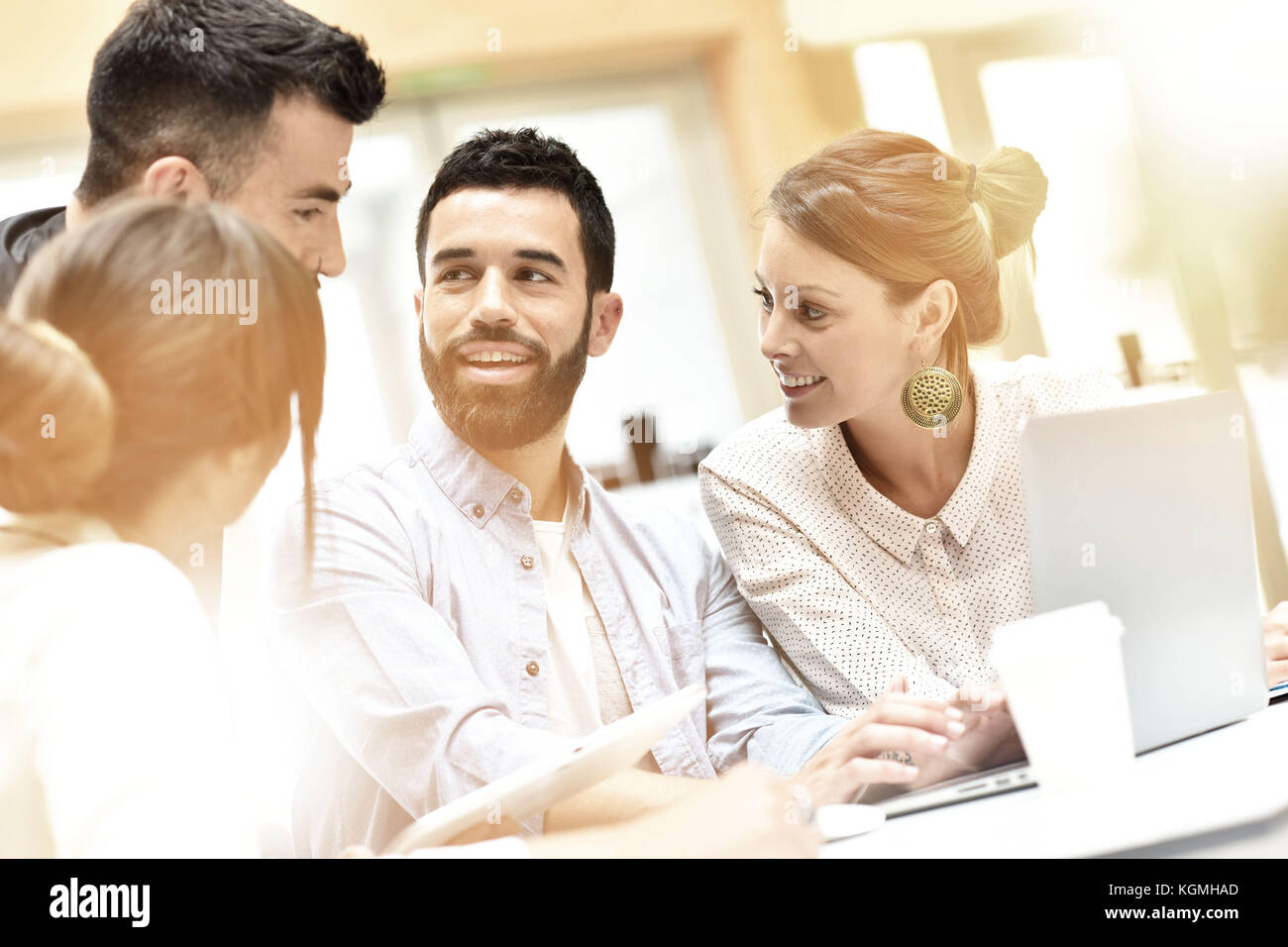 Design team meeting and working on laptop Stock Photo - Alamy