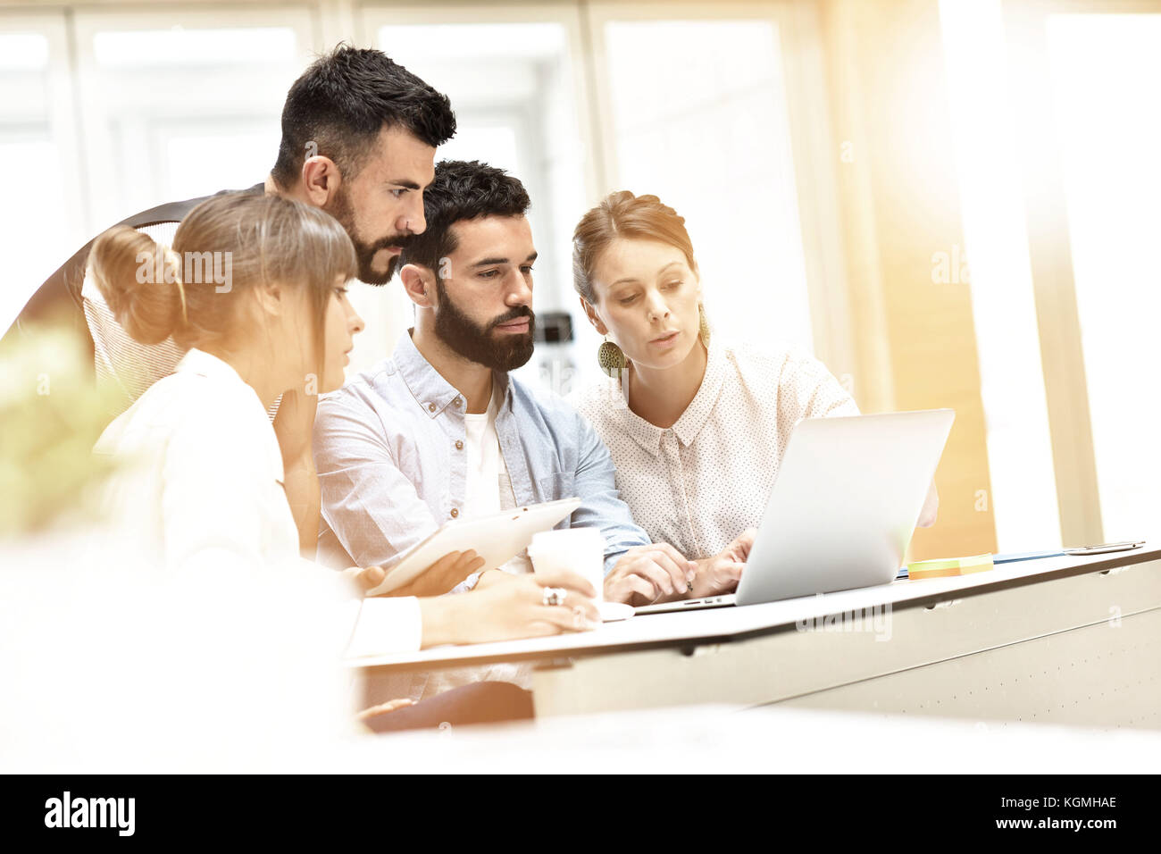 Design team meeting and working on laptop Stock Photo - Alamy