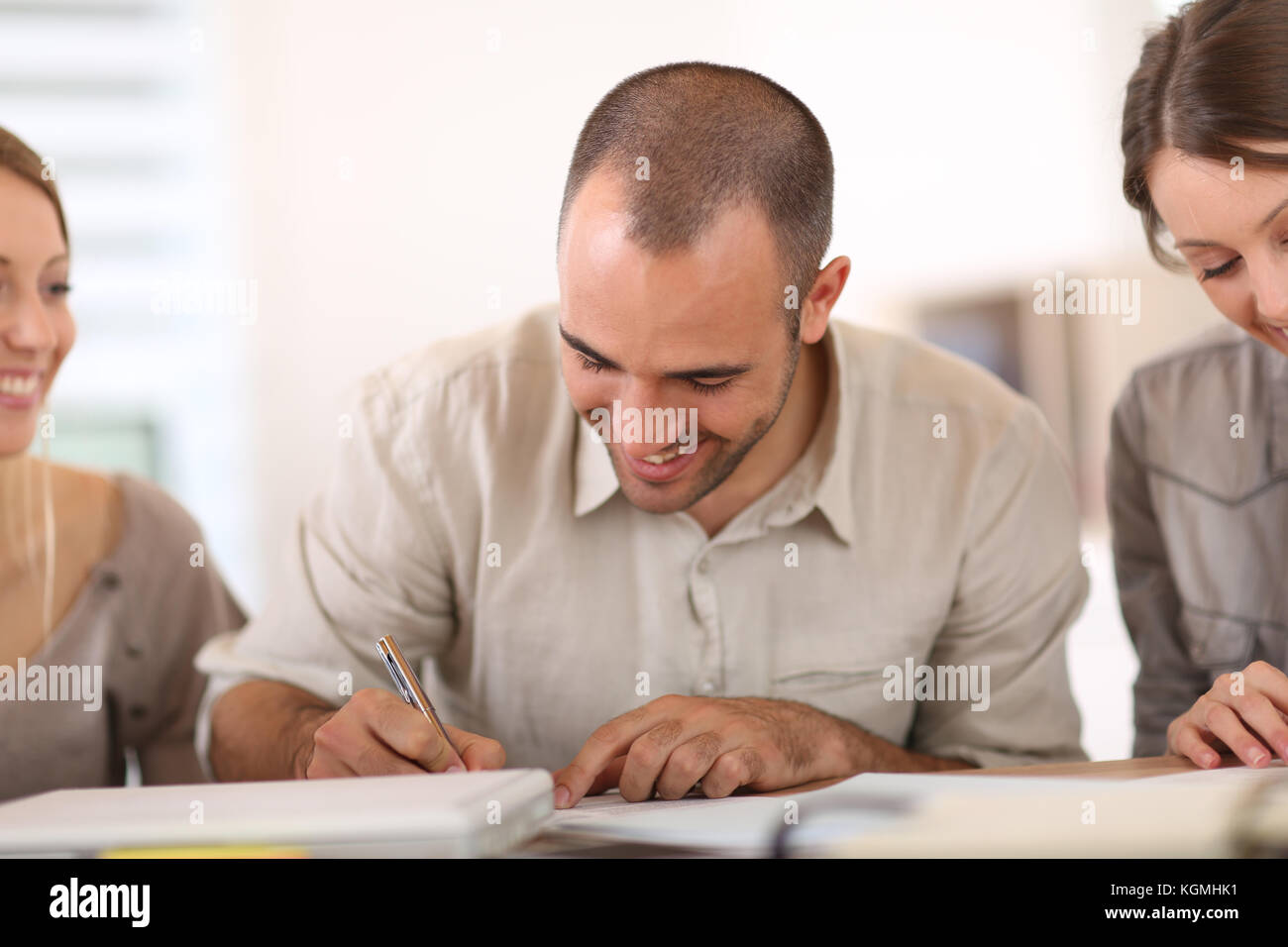 Portrait of young man filling in application form Stock Photo - Alamy