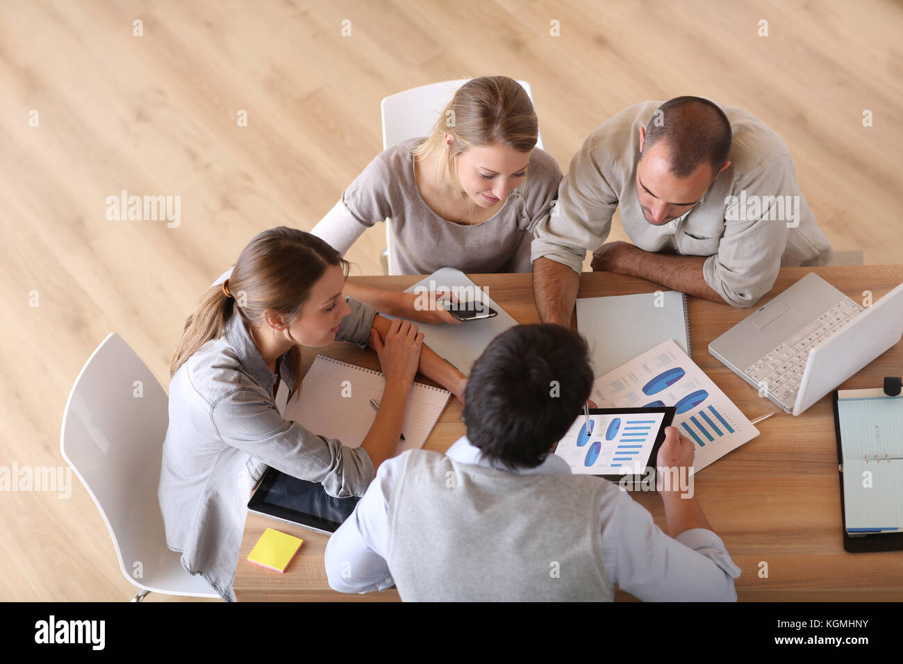 Upper view of business people around table Stock Photo - Alamy