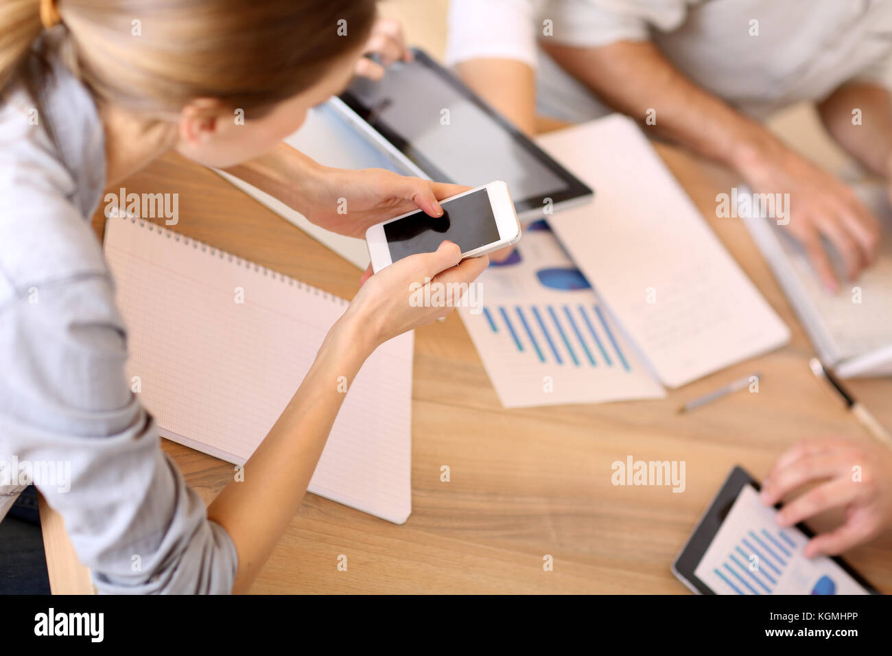 Group of business people using electronic devices at work Stock Photo ...