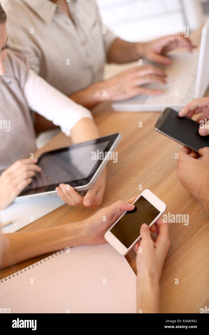 Group of people all using electronics hi-res stock photography and ...