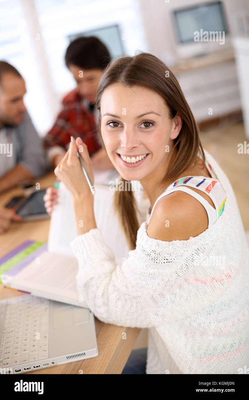 Girl in class studying with laptop and school book Stock Photo - Alamy