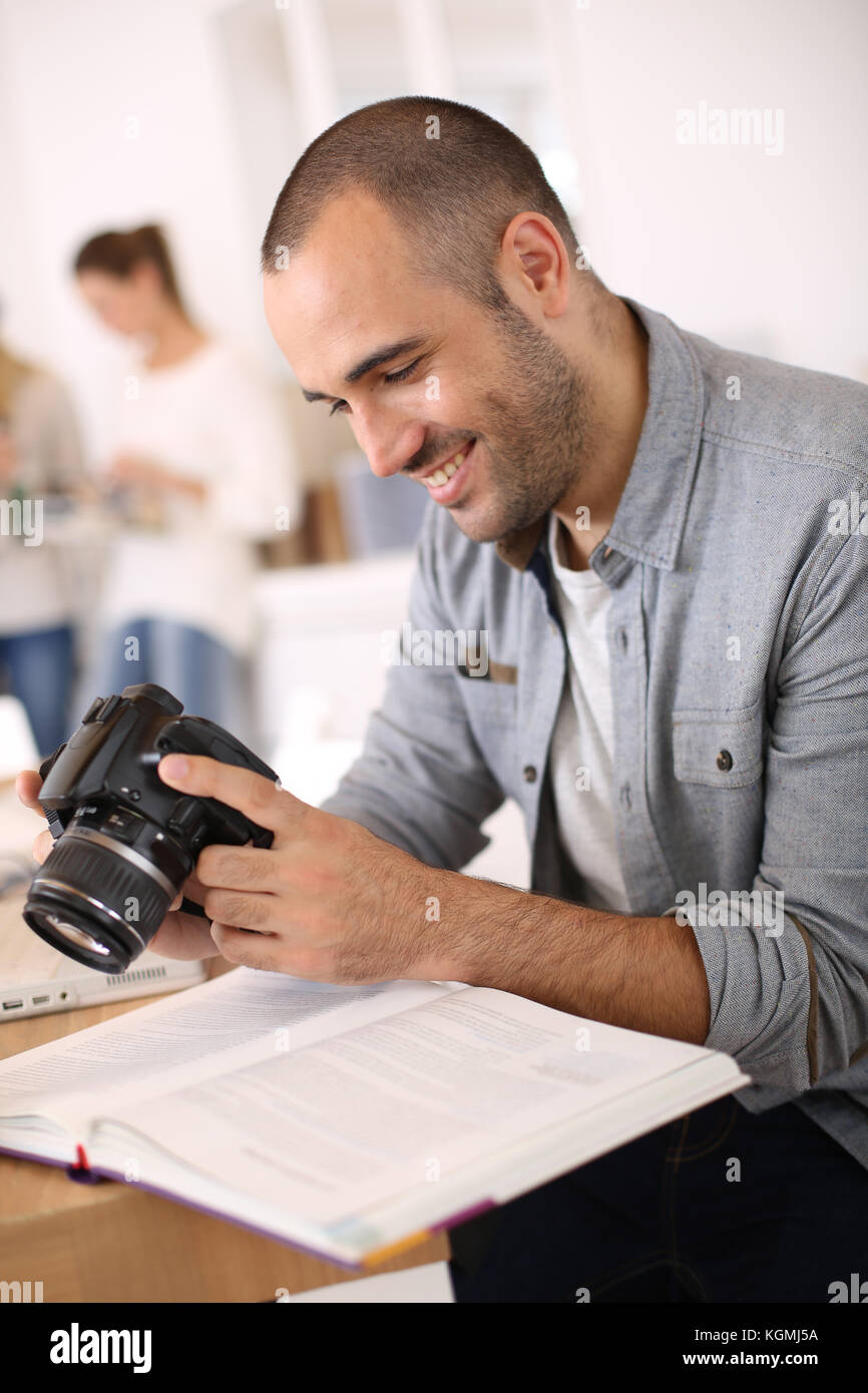 Cheerful reporter working in office on laptop Stock Photo - Alamy