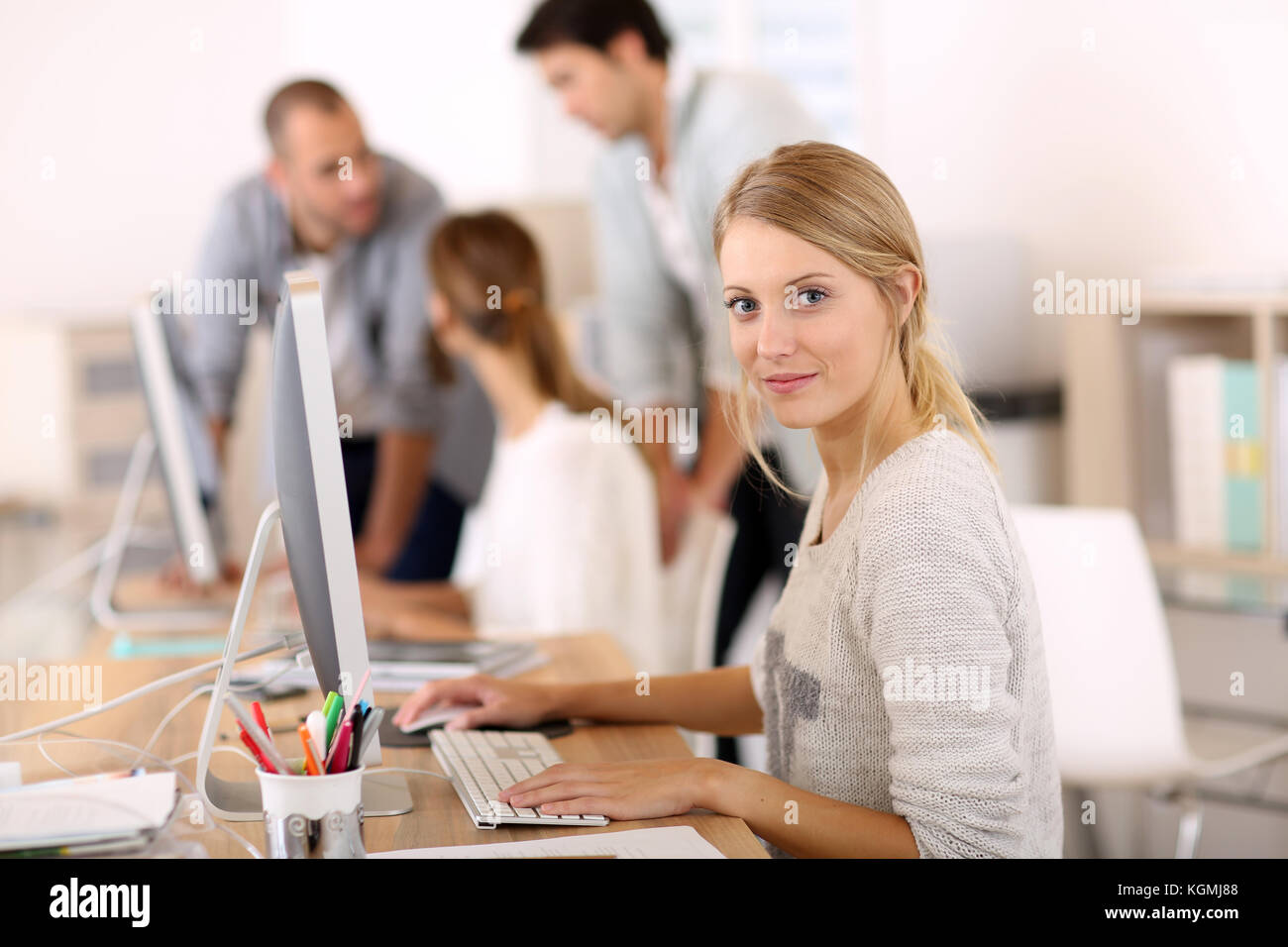 Young girl in office working on desktop computer Stock Photo - Alamy