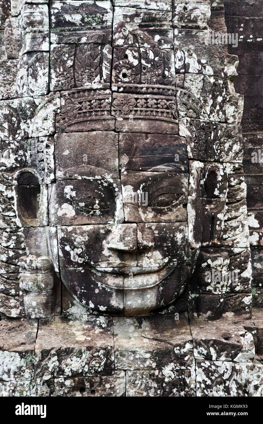 A stone head in the ruins of the Bayon temple, Angkor Wat, Cambodia ...