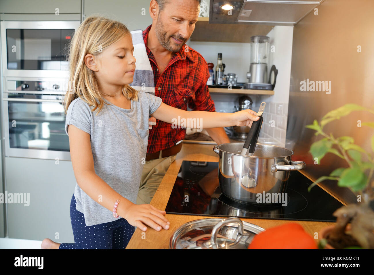 Daddy with daughter cooking together in home kitchen Stock Photo - Alamy